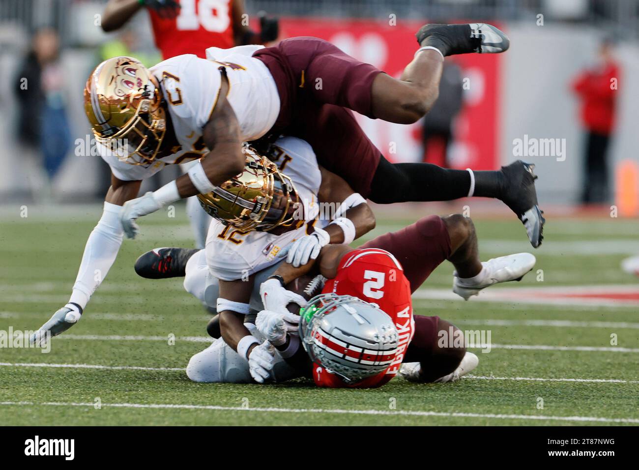 Ohio State receiver Emeka Egbuka, bottom, is tackled by Minnesota ...