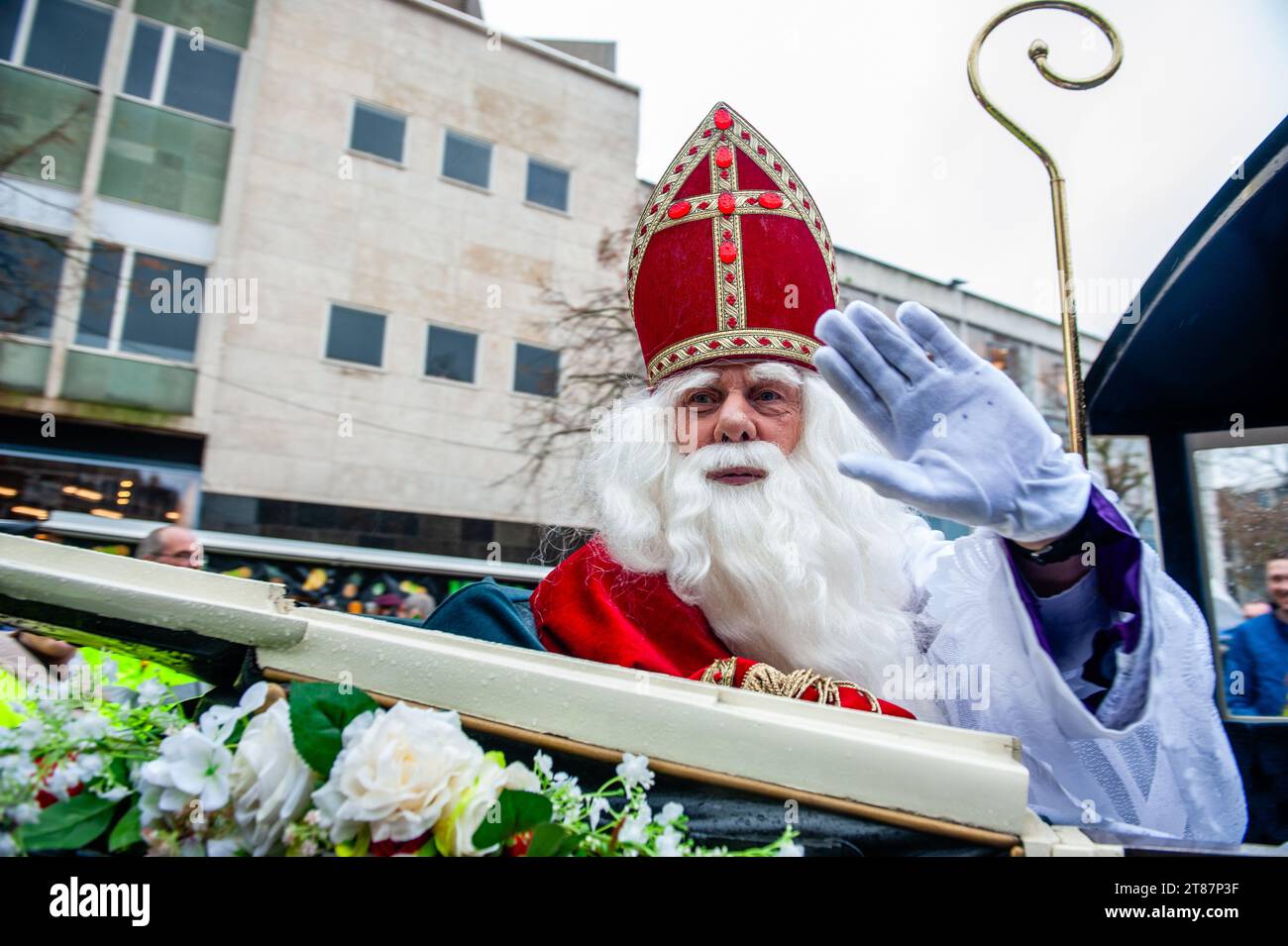 St. Nicholas is seen cheering the audience from a horse-drawn carriage ...