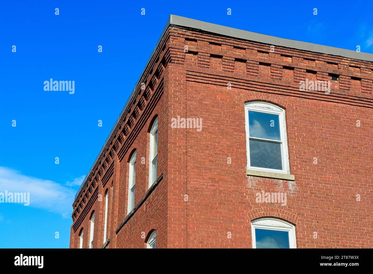 Upper stories of Italianate style brick 1903 building set against ...