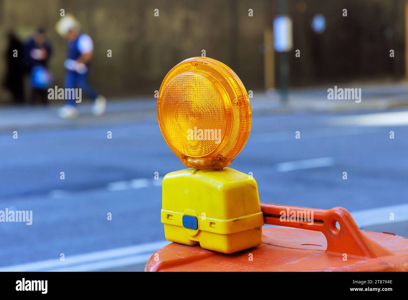 Construction warning lights are displayed on barricade in road that is ...