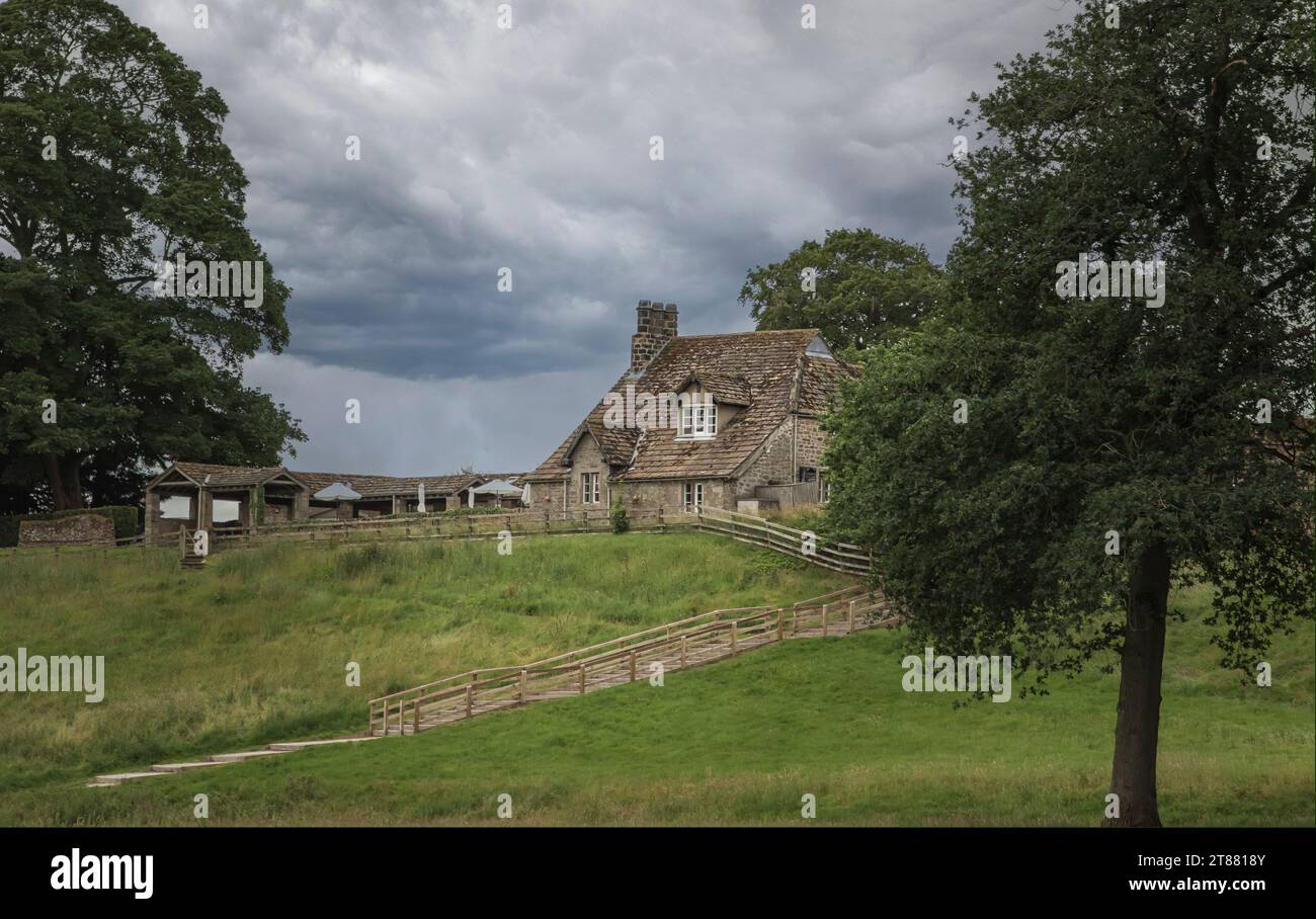 Traditional Yorkshire stone cottage at the top of a slope with a ...
