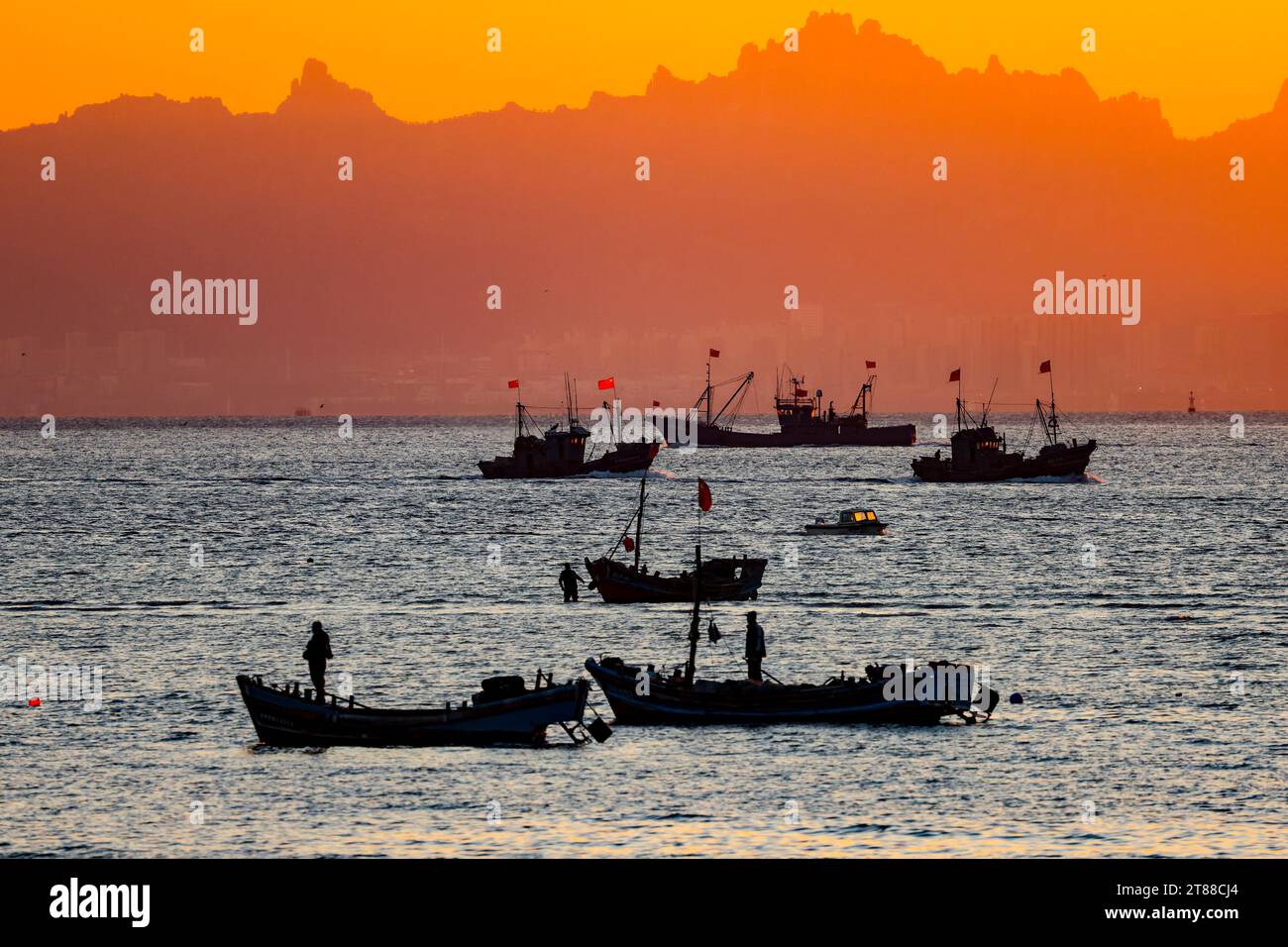 QINGDAO, CHINA - NOVEMBER 18, 2023 - Fishing boats sailing on the coast ...