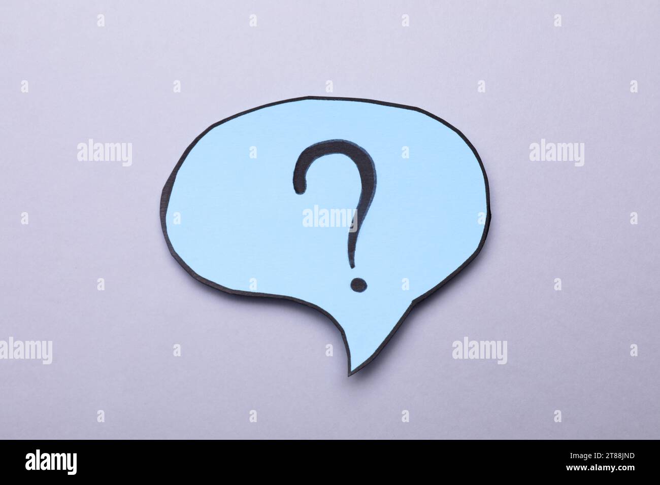 Paper speech bubble with question mark on light grey background, top ...