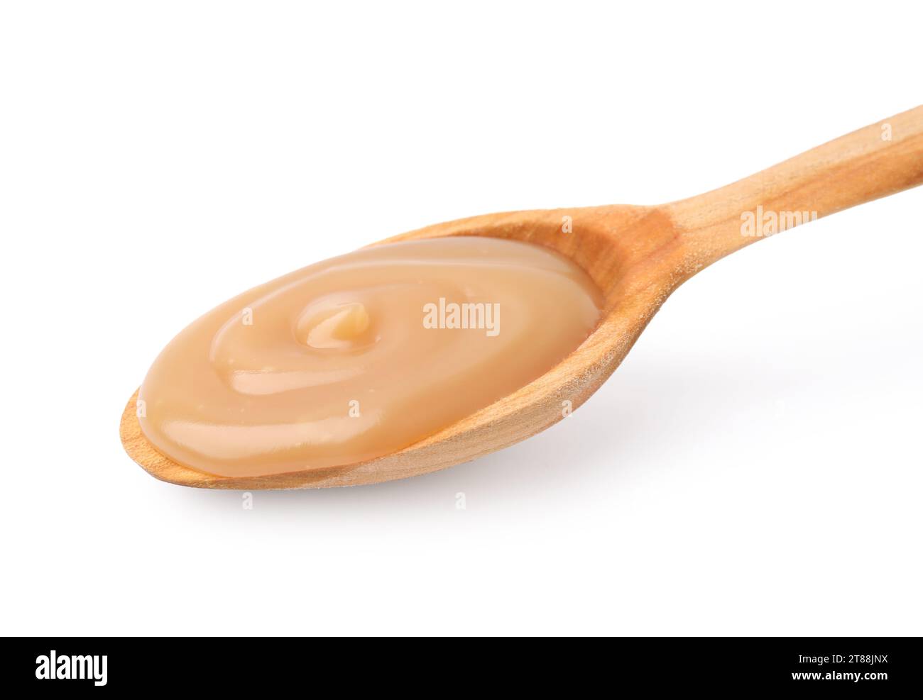 Wooden spoon with tasty salted caramel isolated on white Stock Photo ...