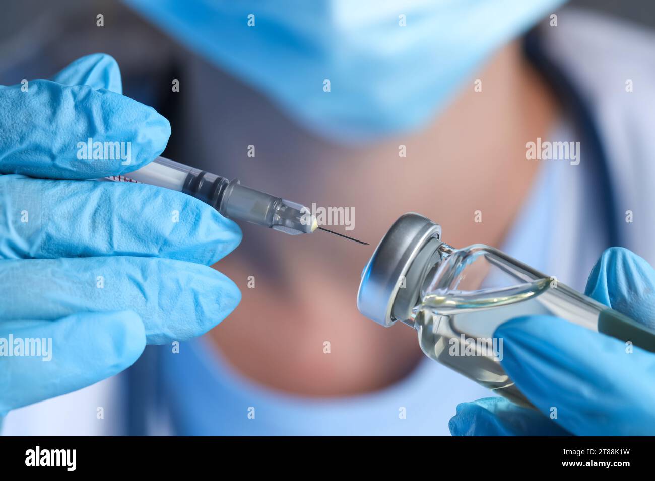 Doctor inserting syringe into glass vial with medication, closeup Stock ...