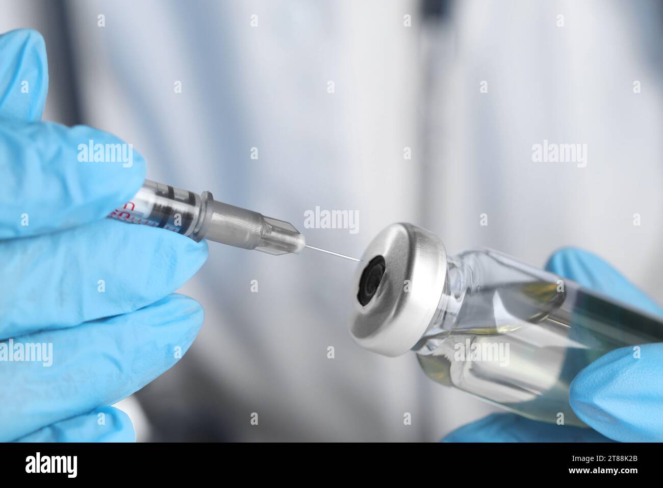 Doctor inserting syringe into glass vial with medication, closeup Stock ...
