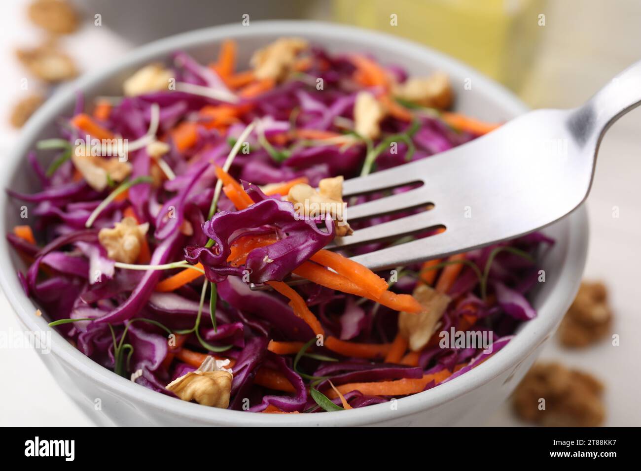 Tasty salad with red cabbage and walnuts at white table, closeup Stock ...