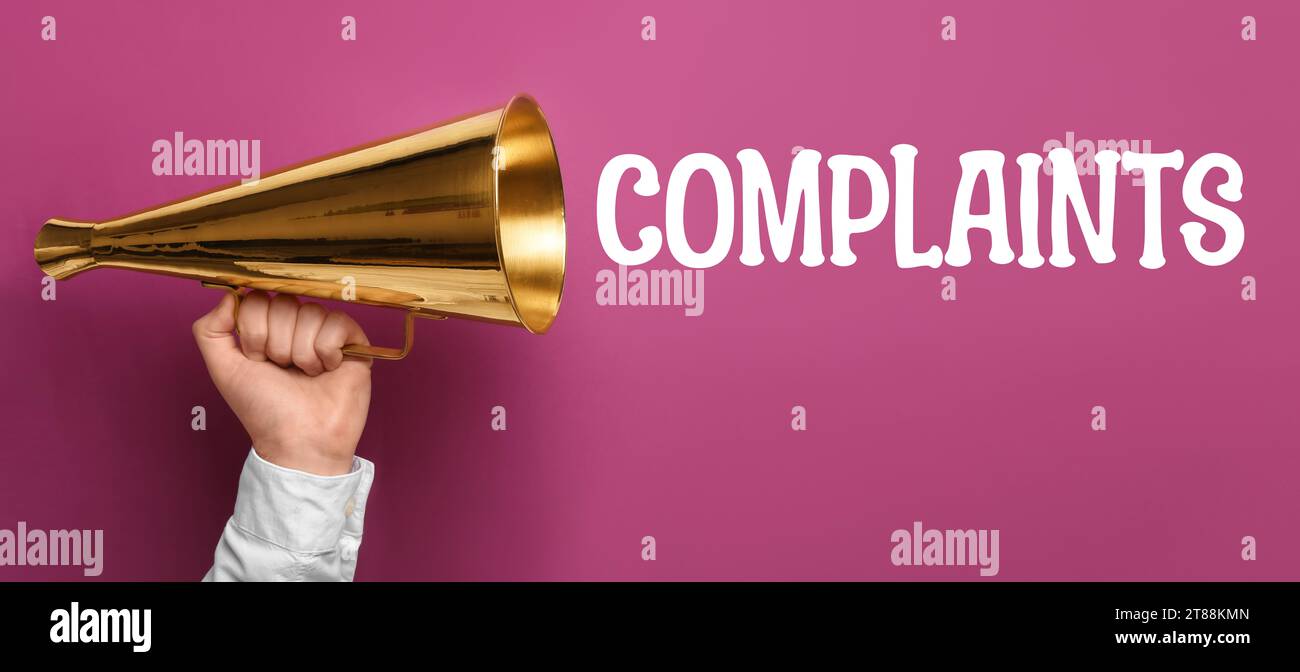 Man holding retro megaphone on purple background, closeup. Word ...
