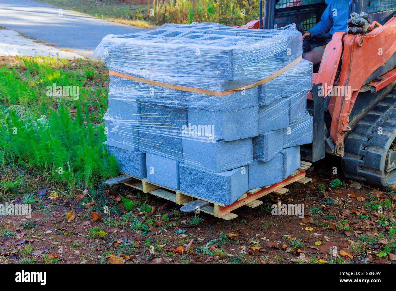 Unloading pallets of concrete blocks for retaining walls with small ...