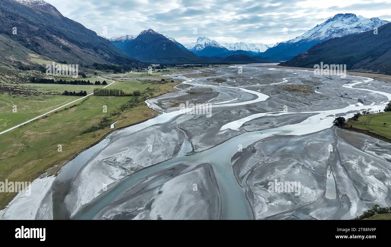 Aerial drone scenery of the braided Dart river flowing through a rural ...