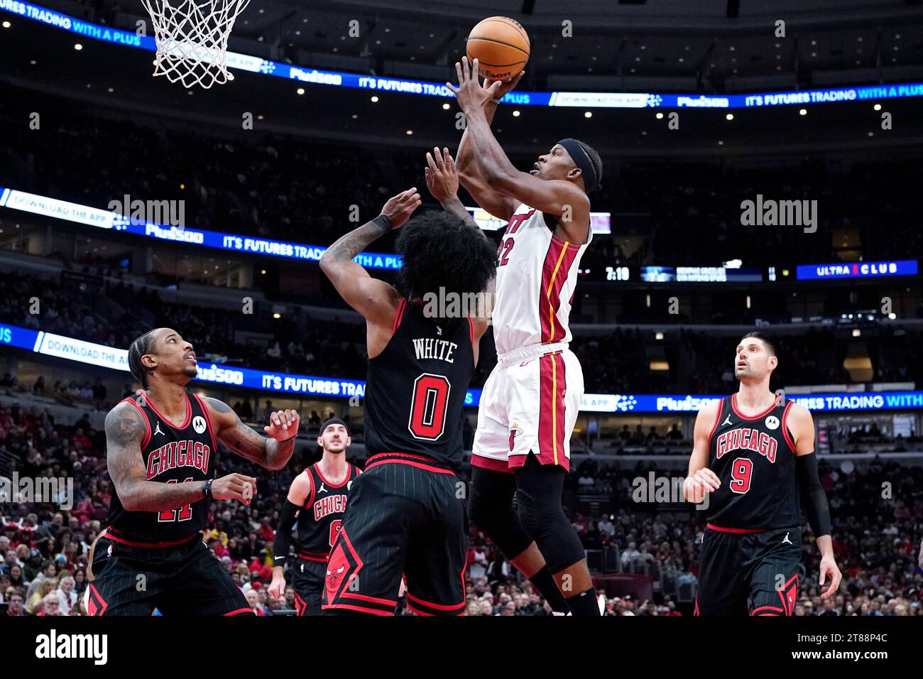 Miami Heat forward Jimmy Butler, second from right, goes up to shoot ...