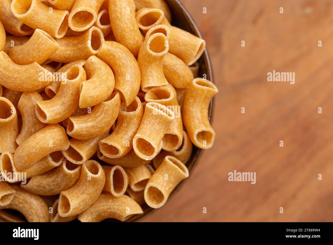 Bowl of Gluten Free Dry Brown Rice Elbow Macaroni Pasta on a Wooden ...