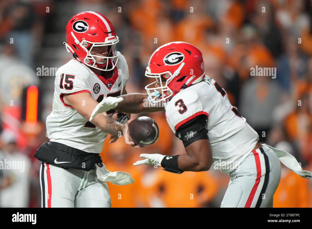 November 18, 2023: Carson Beck #15 hands the ball to Andrew Paul #3 of ...