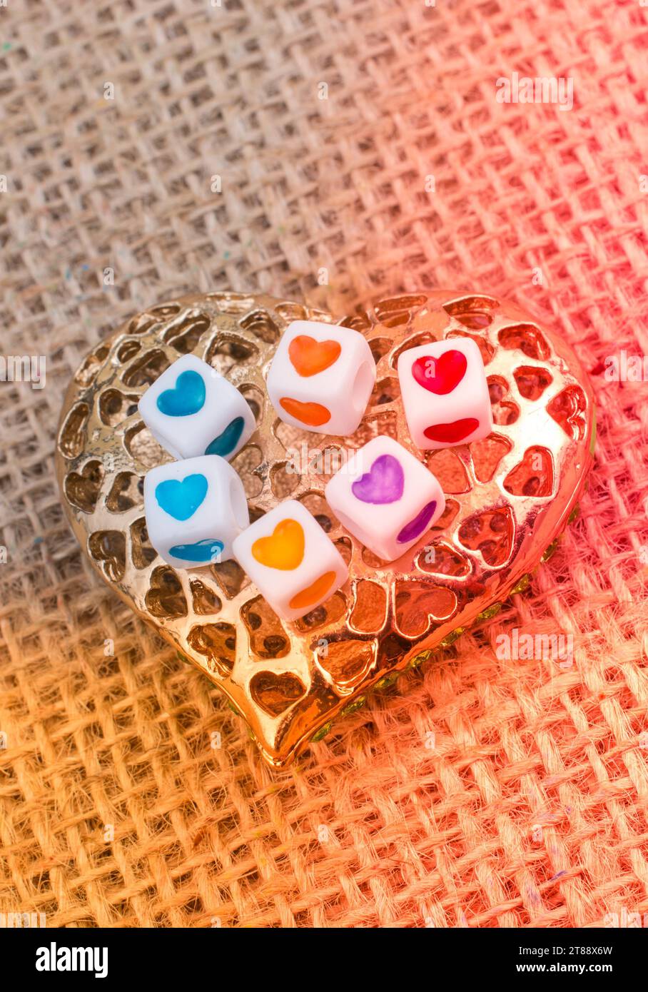 Heart cubes on Heart shaped gold color object Stock Photo - Alamy