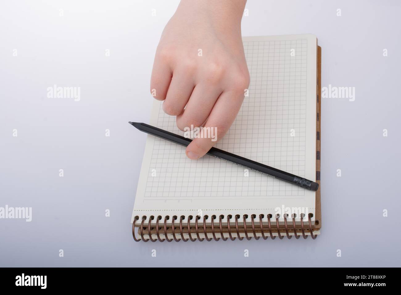 Human hand using pen to write down short note on notebook Stock Photo ...