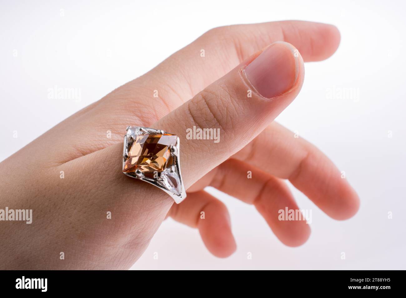 Hand wearing a ring on a white background Stock Photo - Alamy