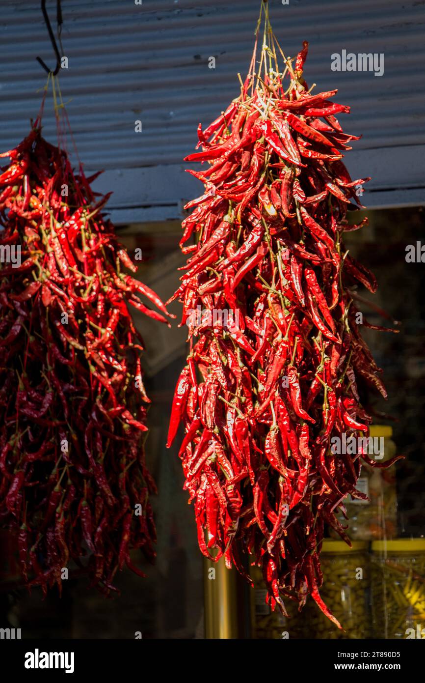 Bundles of red peppers dry in the sun Stock Photo - Alamy