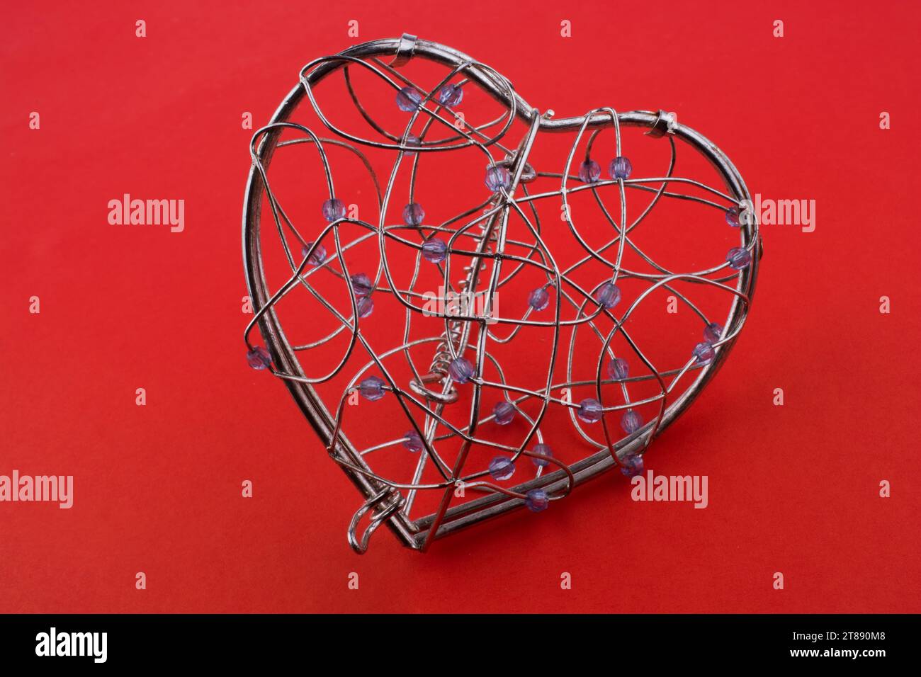 Heart cage on a red background Stock Photo - Alamy