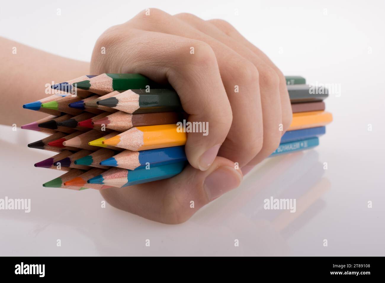 Hand holding color pencils on a white background Stock Photo - Alamy