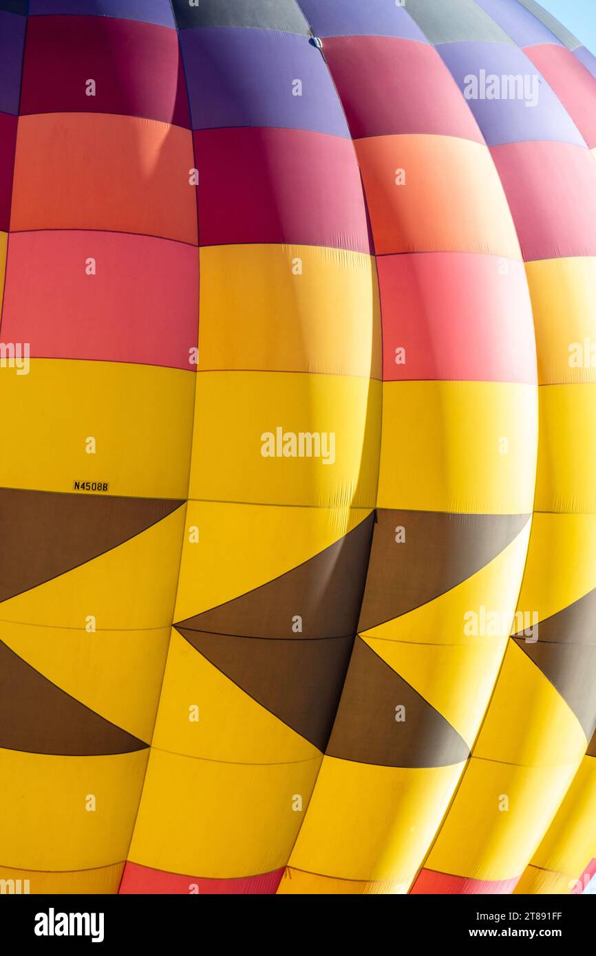 Detail of an inflating hot air balloon with chevron designs, and purple ...
