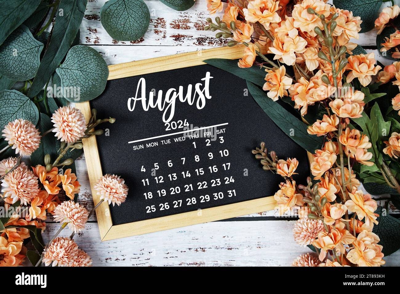 August 2024 monthly calendar with flower bouquet decoration on wooden ...