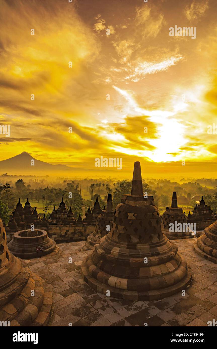 Stone stupa of the ancient Buddhist temple complex Borobudur at sunrise ...