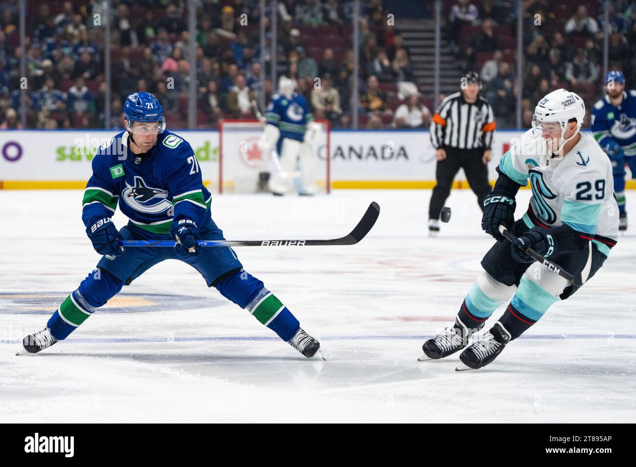 Vancouver Canucks' Nils Hoglander (21) passes the puck infront of ...
