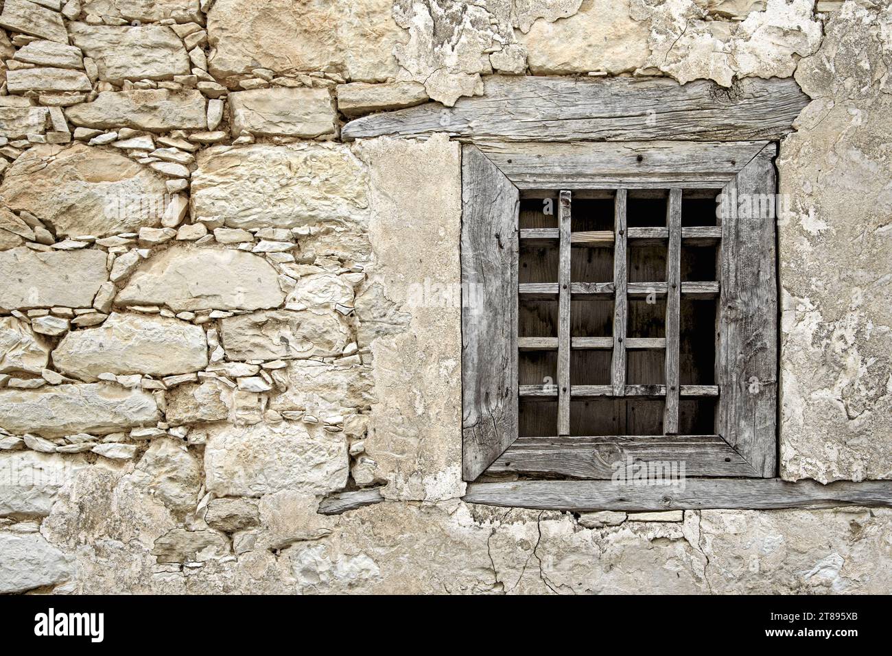 Broken wooden lattice in a window frame in the village of Omodos ...