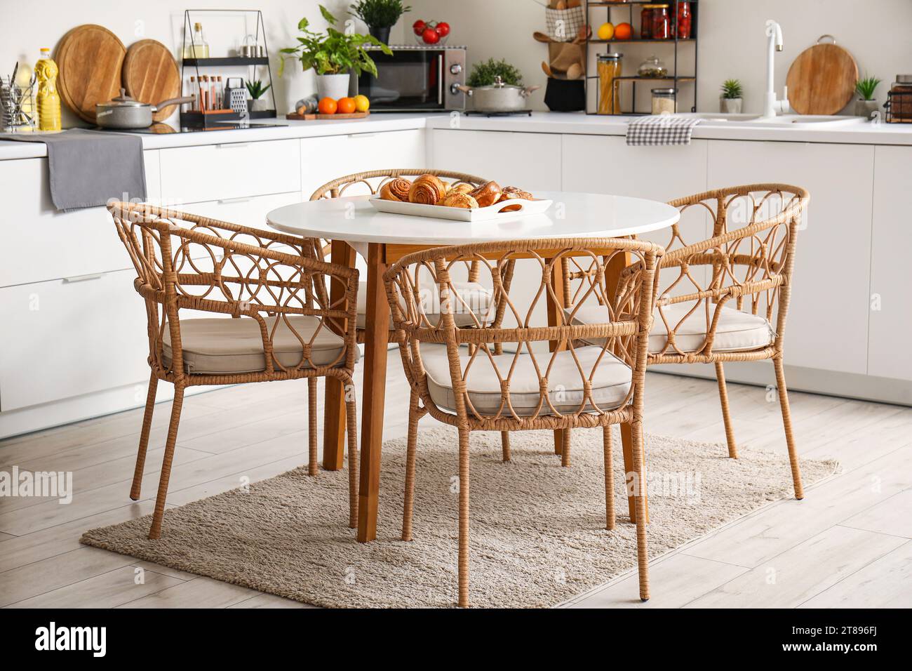 Interior of modern kitchen with wooden dining table Stock Photo - Alamy