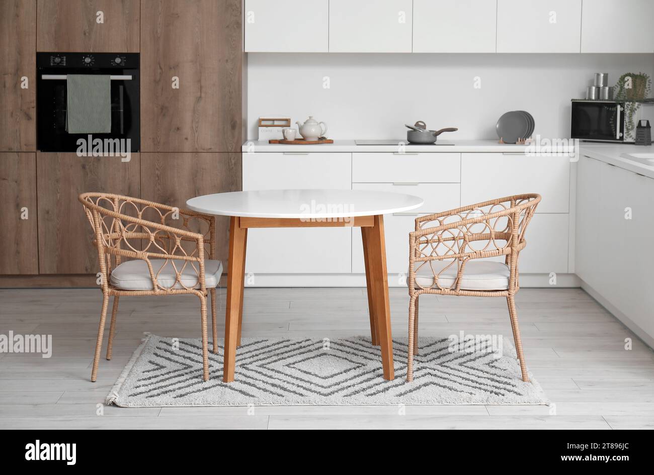 Interior of modern kitchen with clean dining table Stock Photo - Alamy