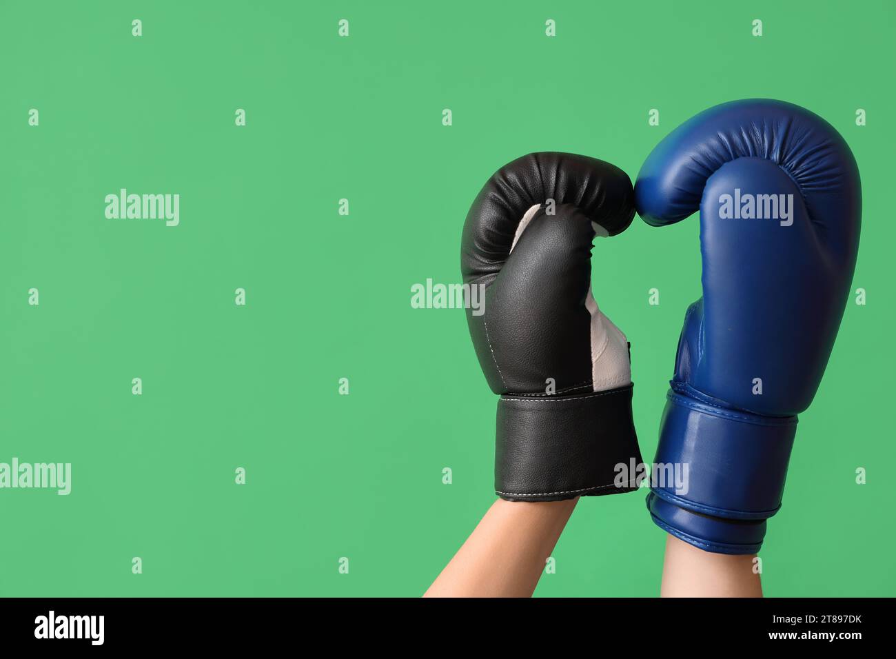 Female hands in boxing gloves on green background Stock Photo - Alamy