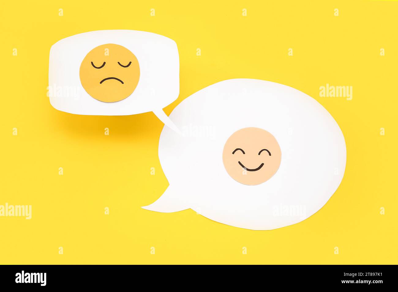 Speech bubbles with happy and sad faces on yellow background Stock ...