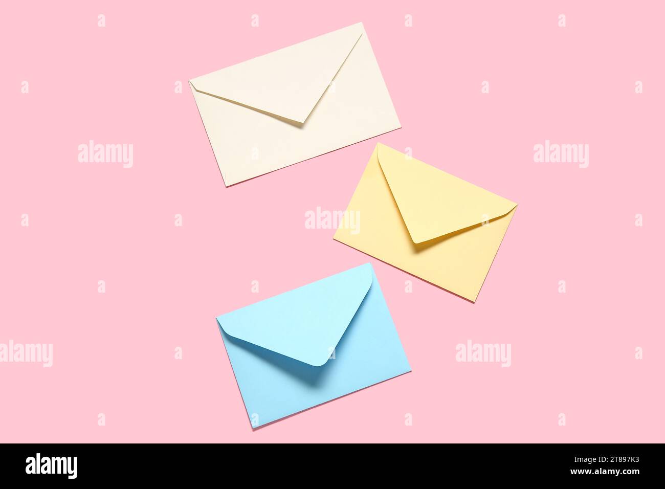 Closed envelopes on pink background Stock Photo - Alamy