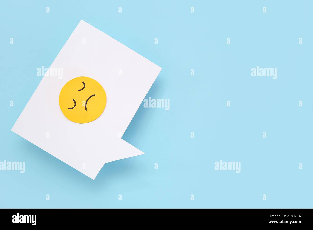 Speech bubble with sad face on blue background Stock Photo - Alamy