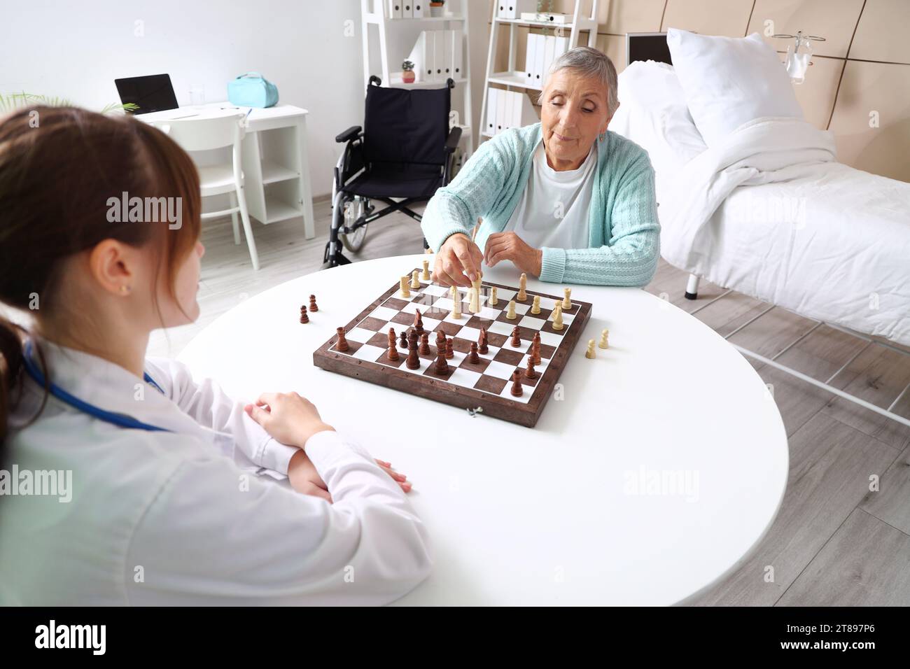 Senior woman with doctor playing chess at nursing home Stock Photo - Alamy