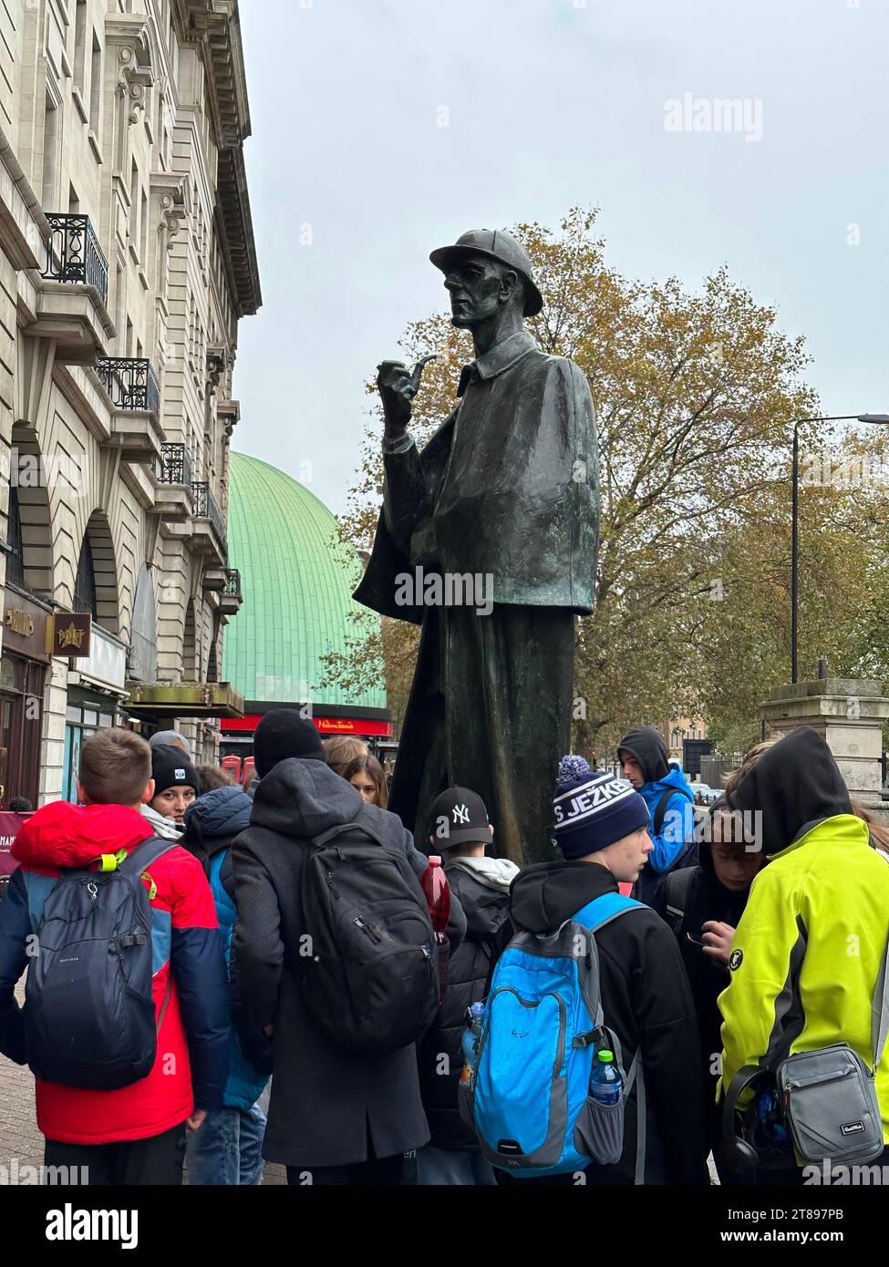 London, UK. 16th Nov, 2023. Pupils stand at a statue of Sherlock Holmes ...