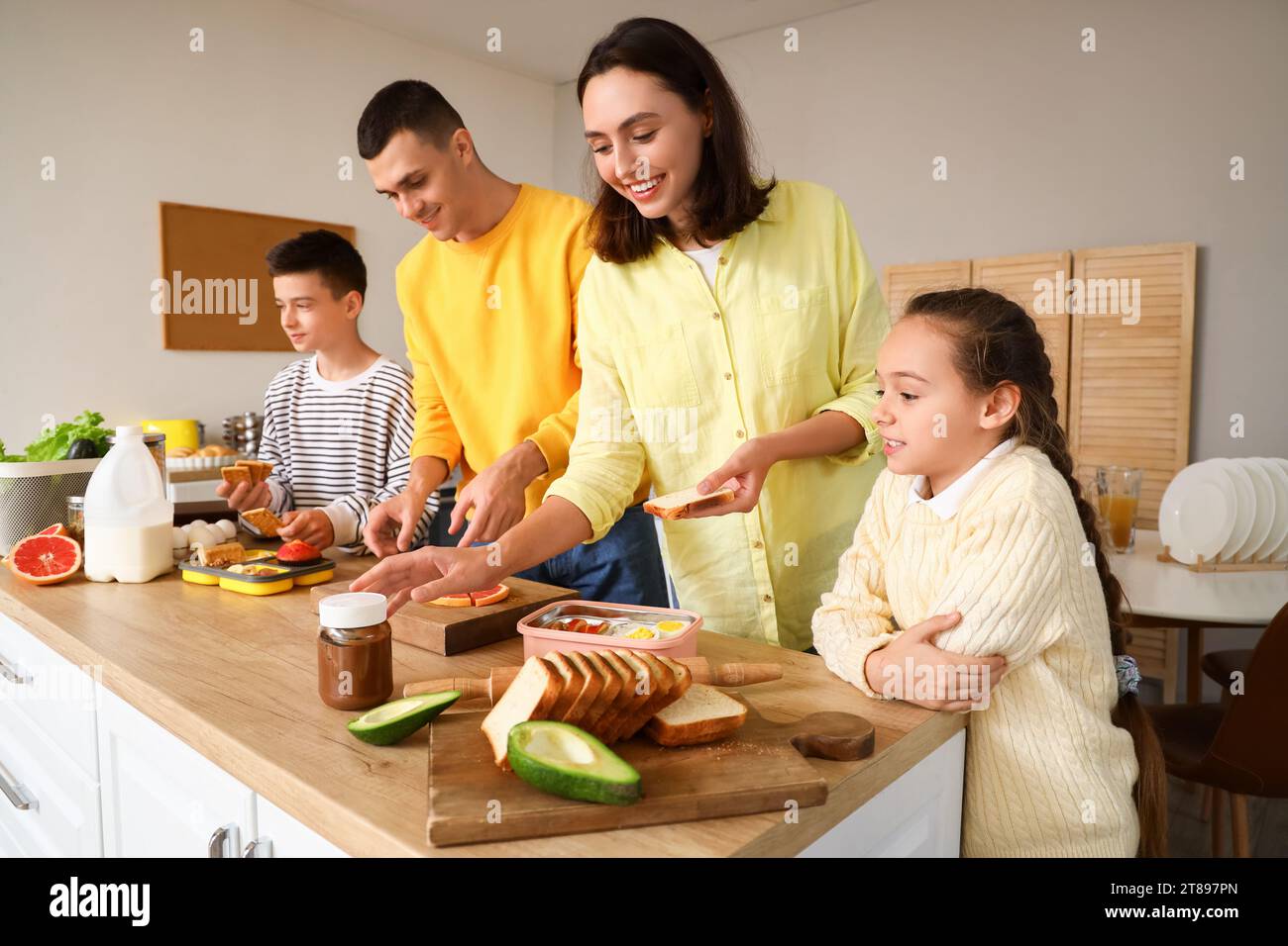 Happy family cooking in kitchen Stock Photo - Alamy
