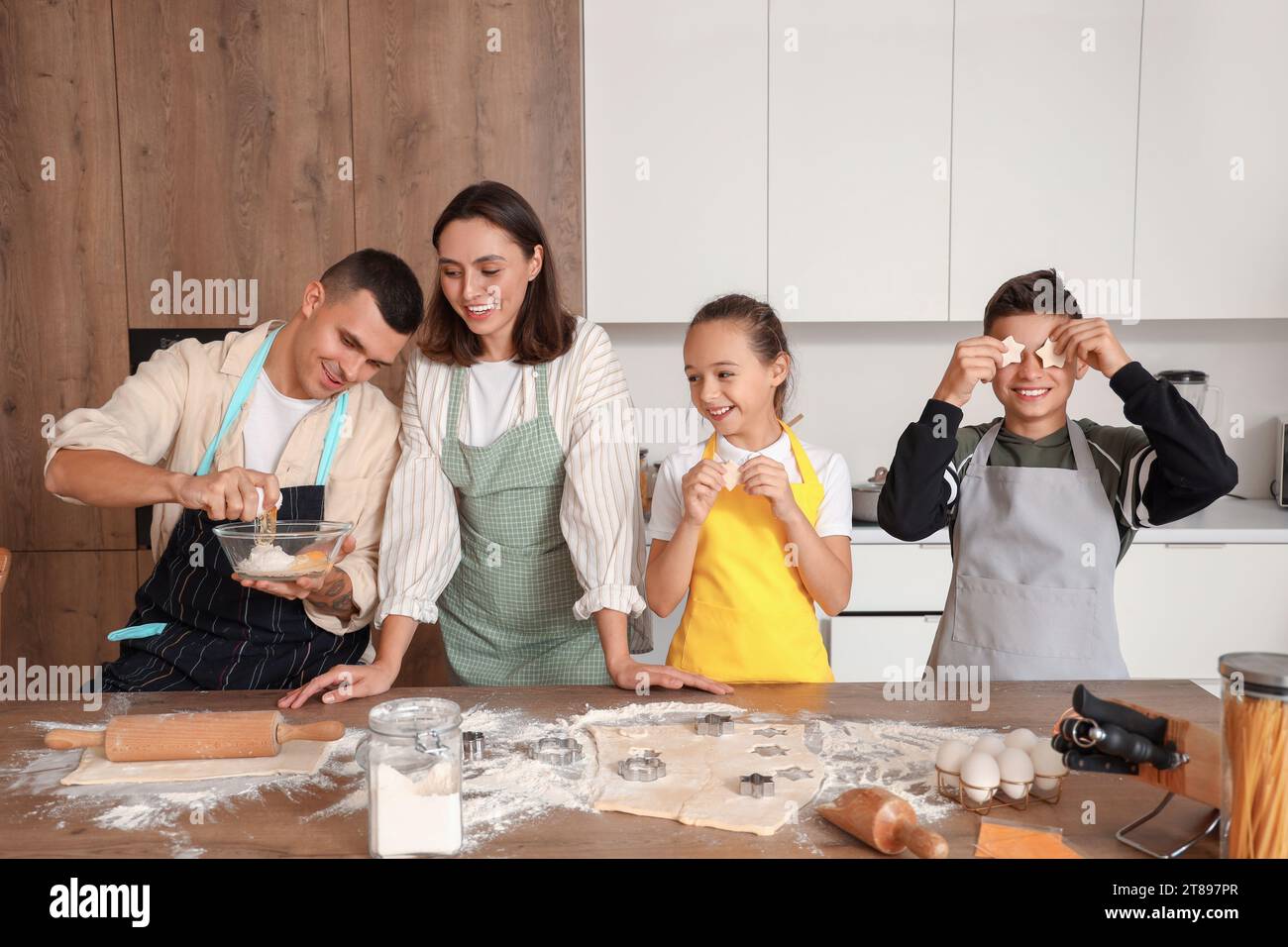 Happy family making cookies in kitchen Stock Photo - Alamy