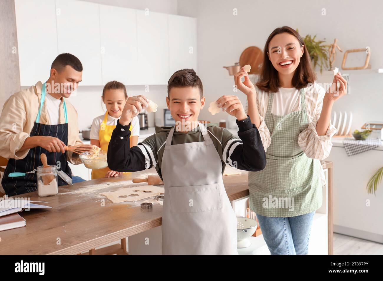 Happy family making cookies in kitchen Stock Photo - Alamy