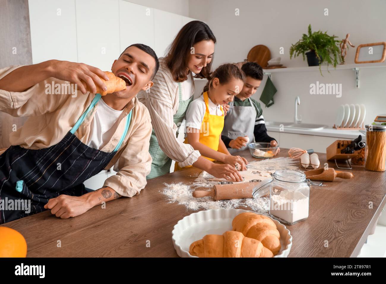 Happy family making cookies in kitchen Stock Photo - Alamy