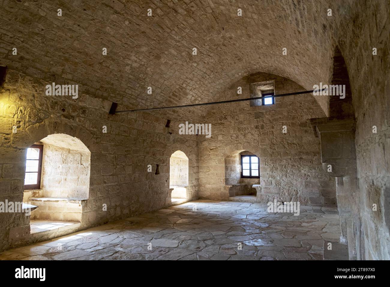 The interior of the medieval castle of Kolossi with arched windows and ...