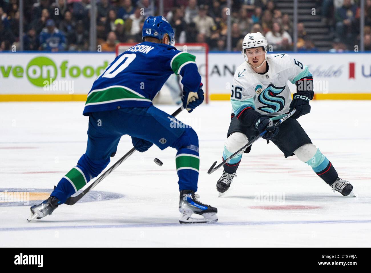Seattle Kraken's Kailer Yamamoto (56) passes the puck past Vancouver ...
