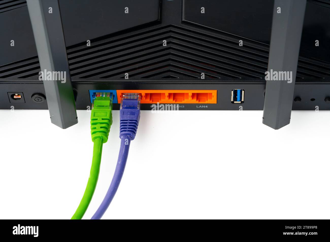 Modern router with cables plugged in close up Stock Photo - Alamy