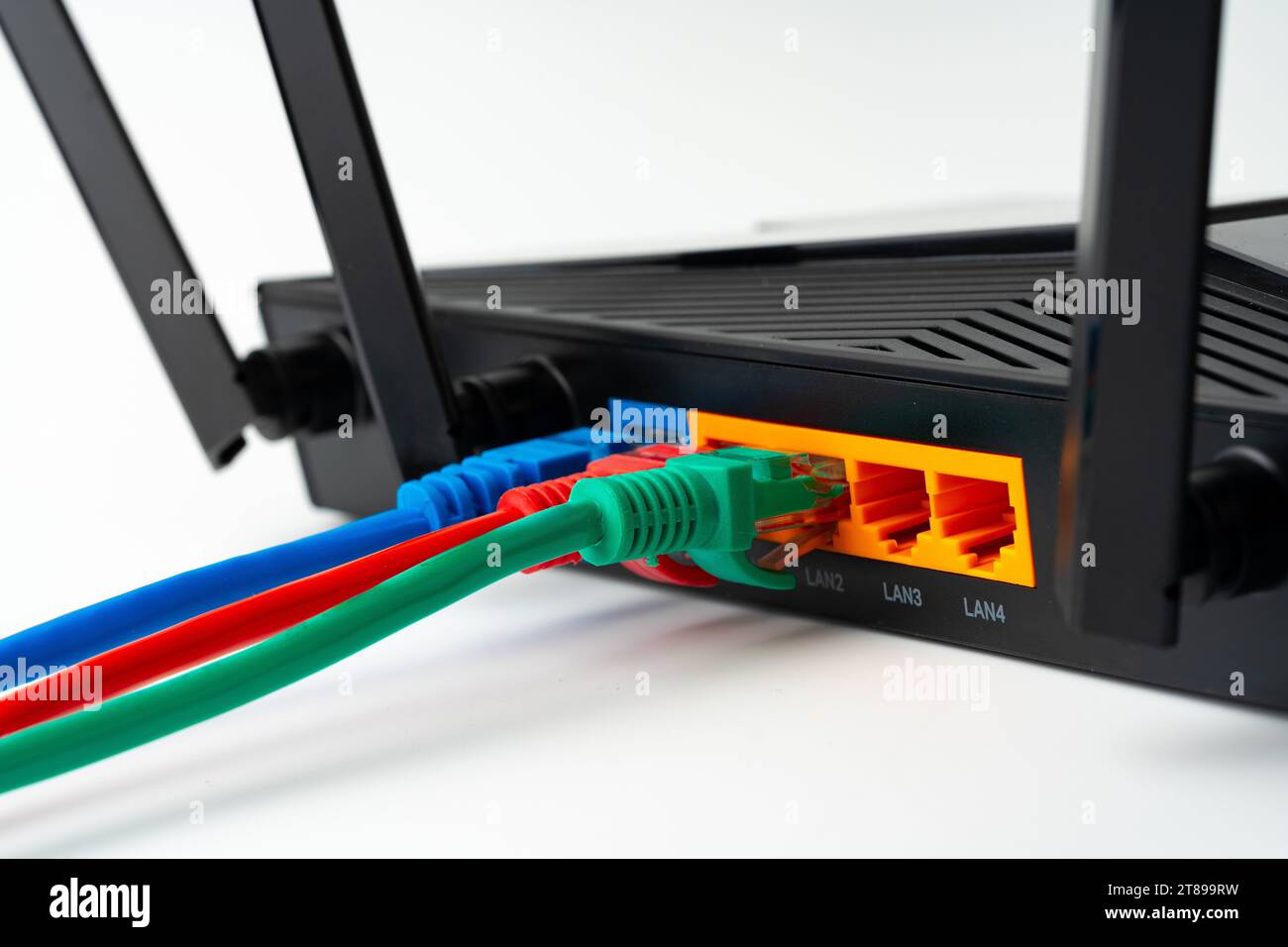 Modern router with cables plugged in close up Stock Photo - Alamy