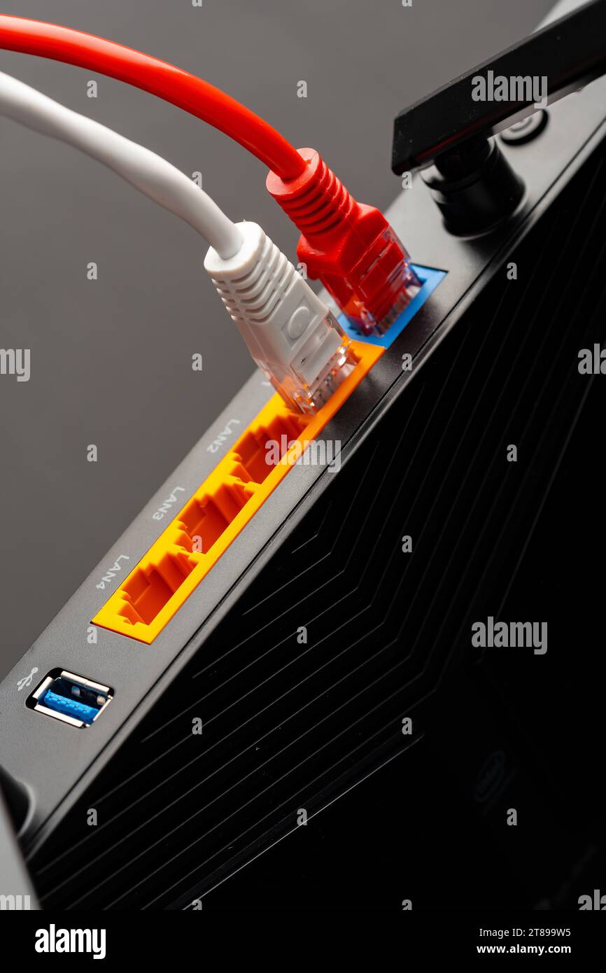 Modern router with cables plugged in close up Stock Photo - Alamy