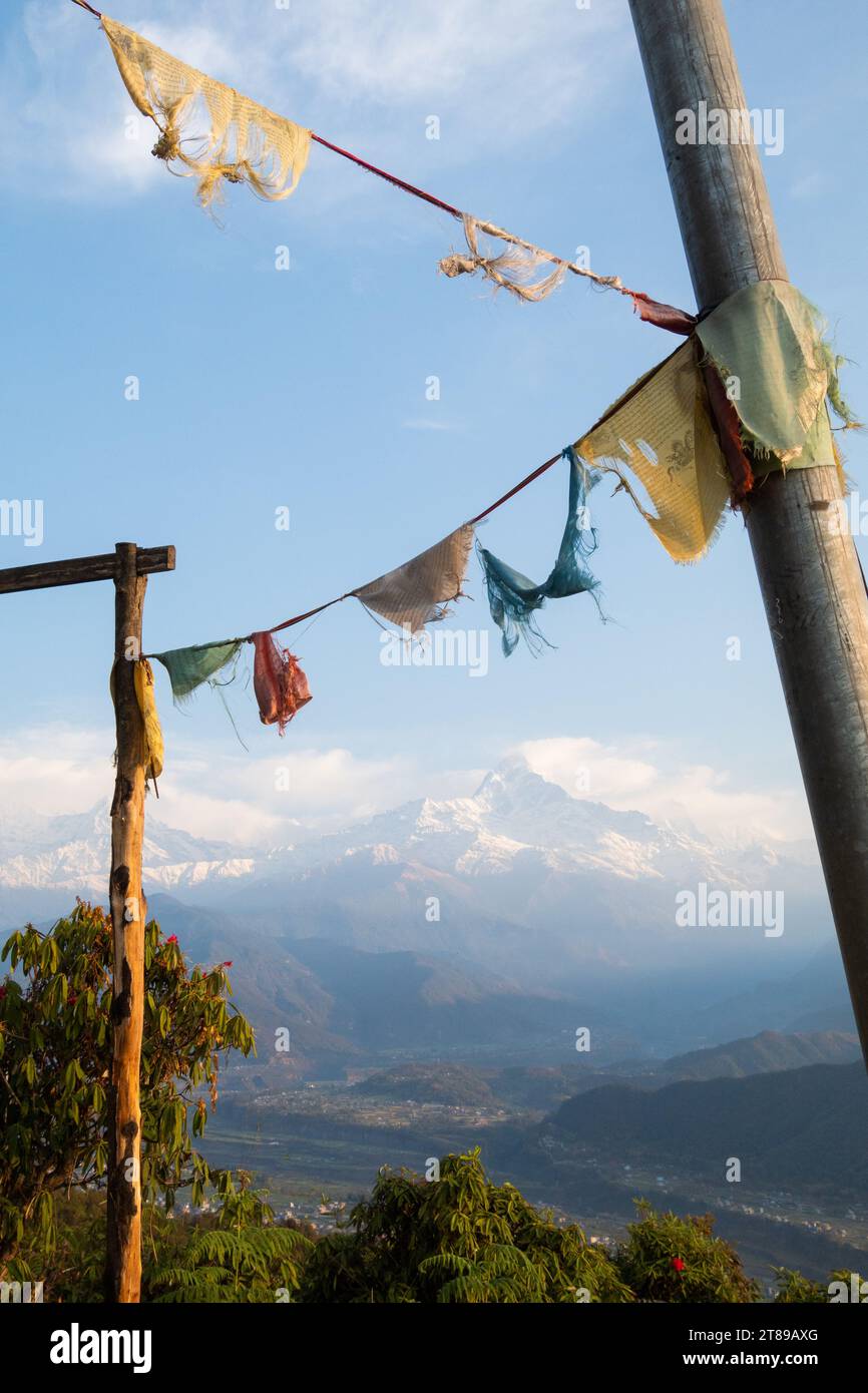 Tibetan prayer flags hang over a view of Machhapuchhare and the Seti ...