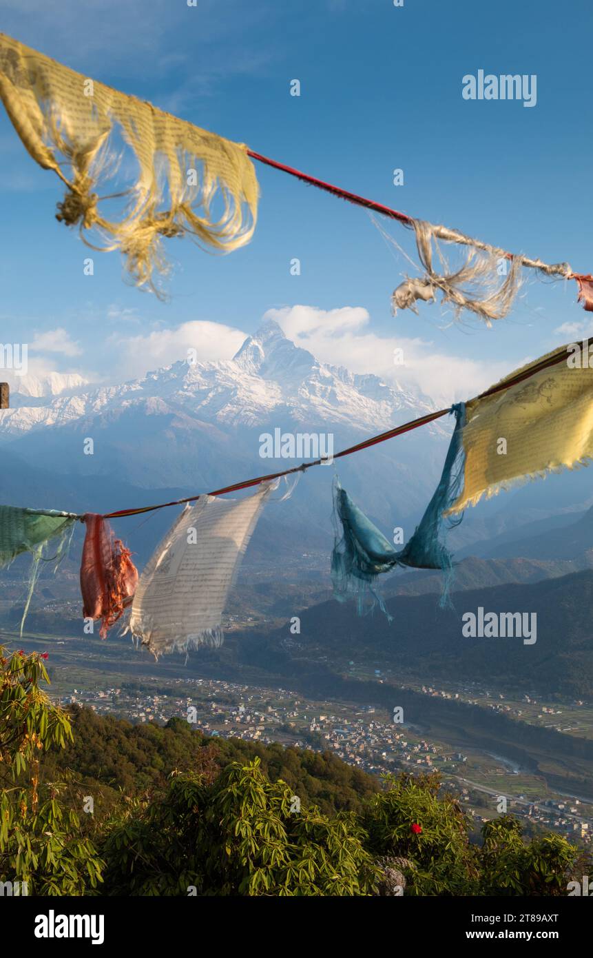 Tibetan prayer flags hang over a view of Machhapuchhare and the Seti ...
