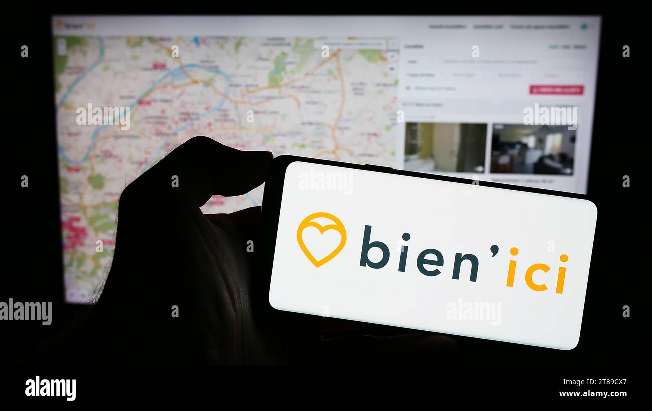 Person holding mobile phone with logo of French real estate research ...