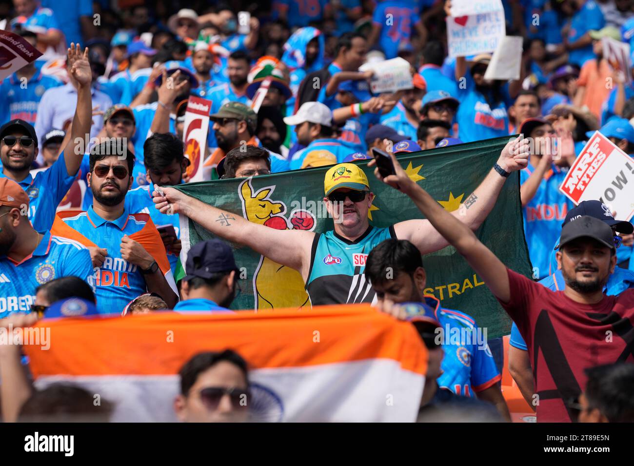 An Australian cricket fan cheers with other before the start of the ICC ...