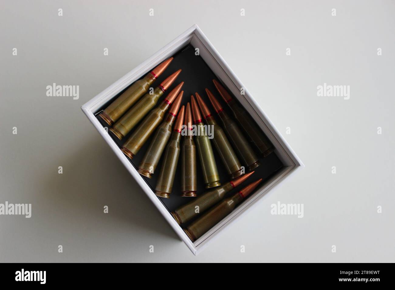Top view of white box with unitary cartridges lined up bullets to ...